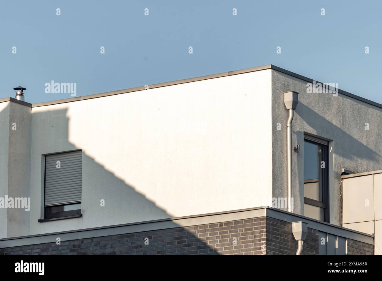 White building facade with shadows and some windows, Bottrop, Germany ...