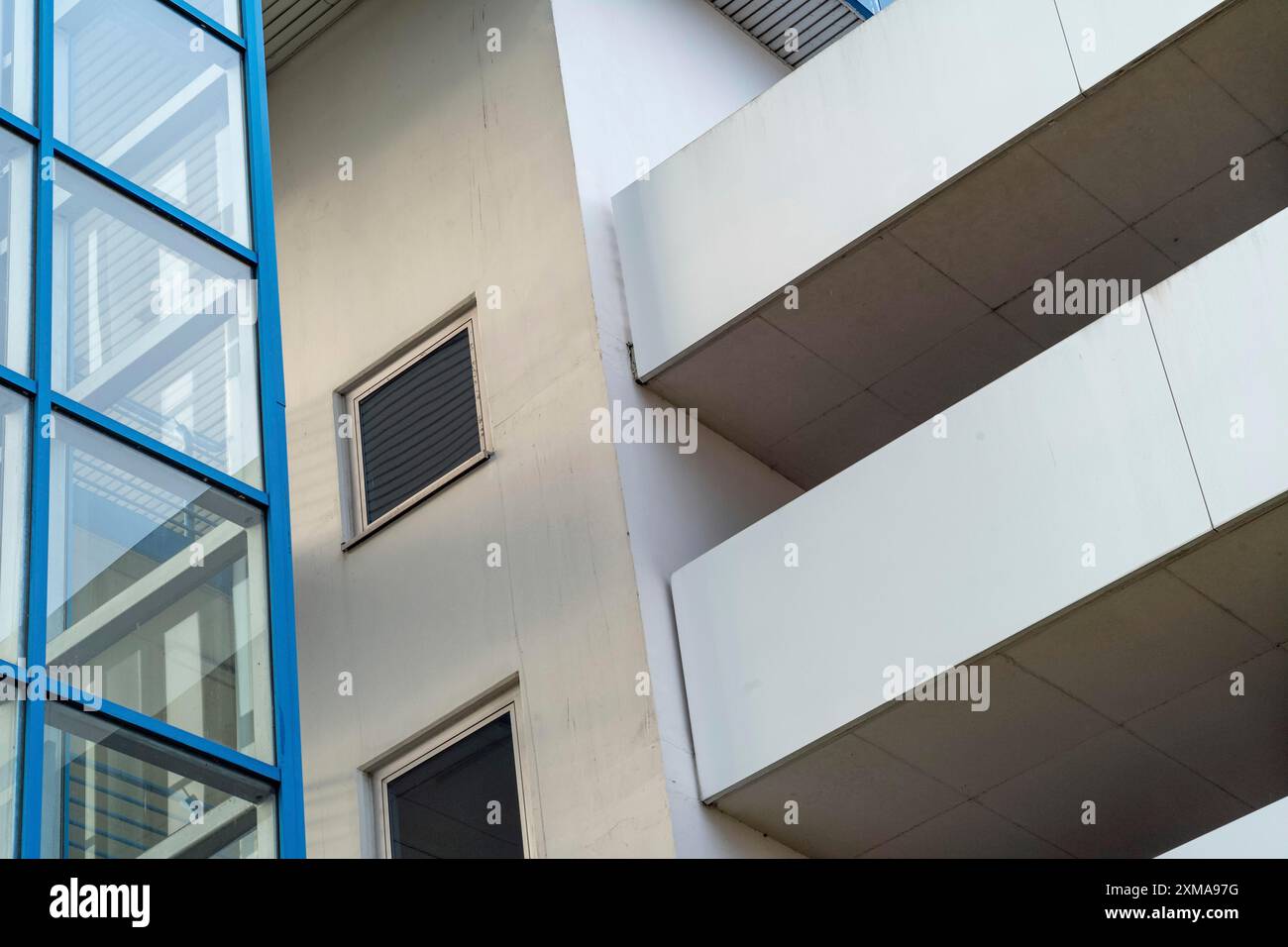The corner of a modern building with windows and reflective glass ...