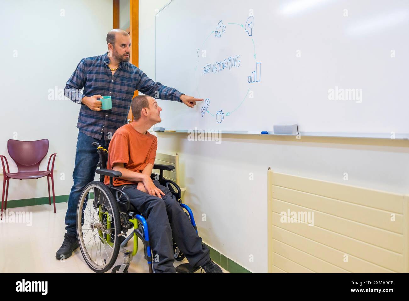 Man with disability and work team during brainstorming in a meeting ...