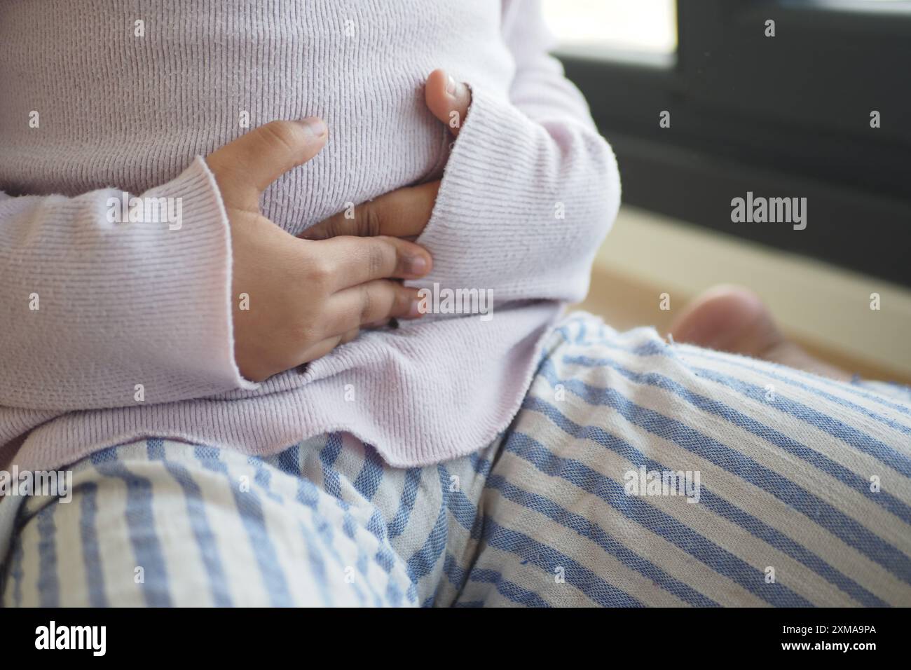 Child suffering stomach pain close hi-res stock photography and images ...