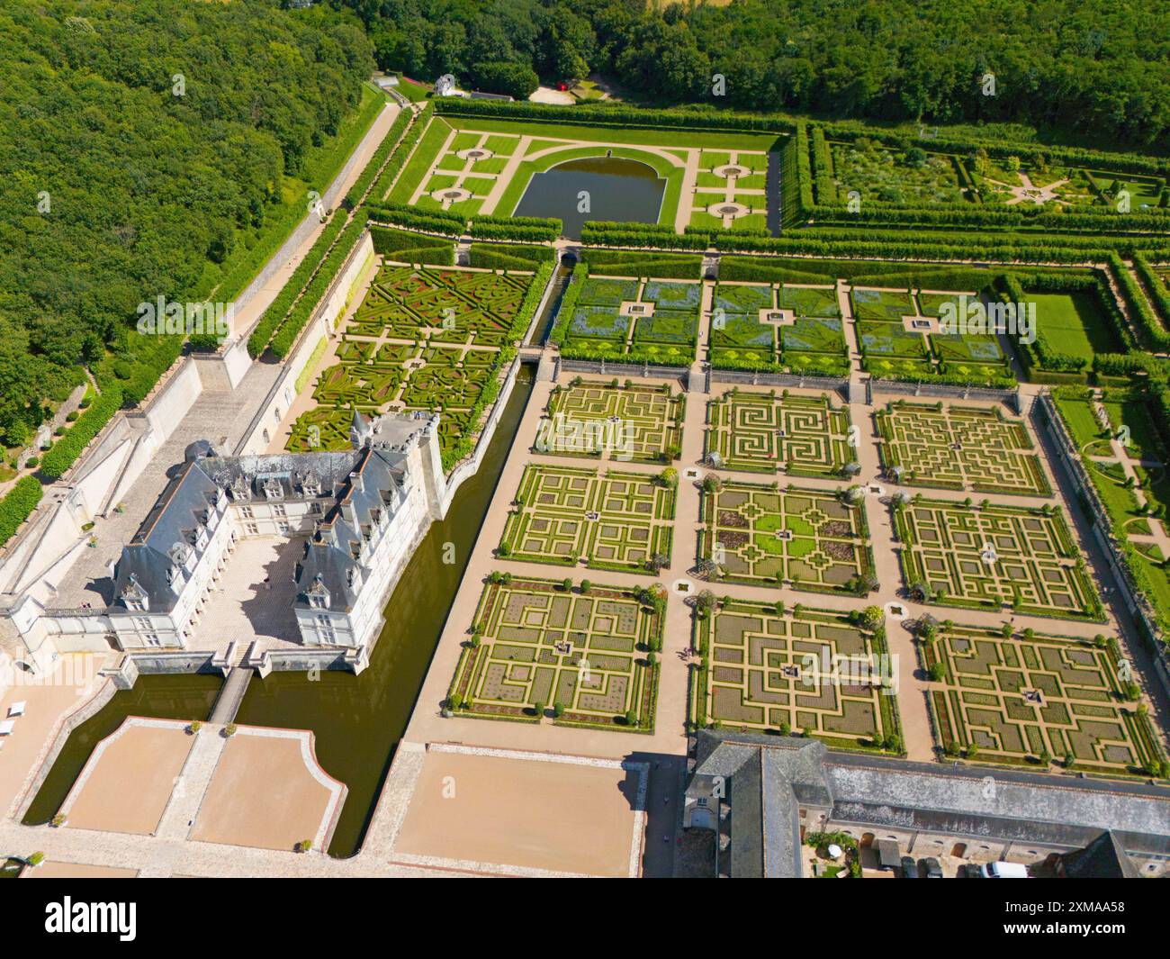 Aerial view of a large castle with symmetrically arranged formal ...