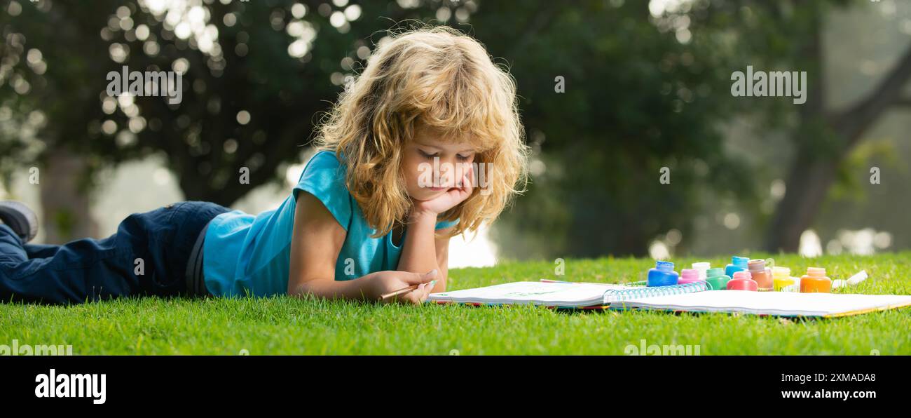 Child drawing. Portrait of smiling happy kid enjoying art and craft ...