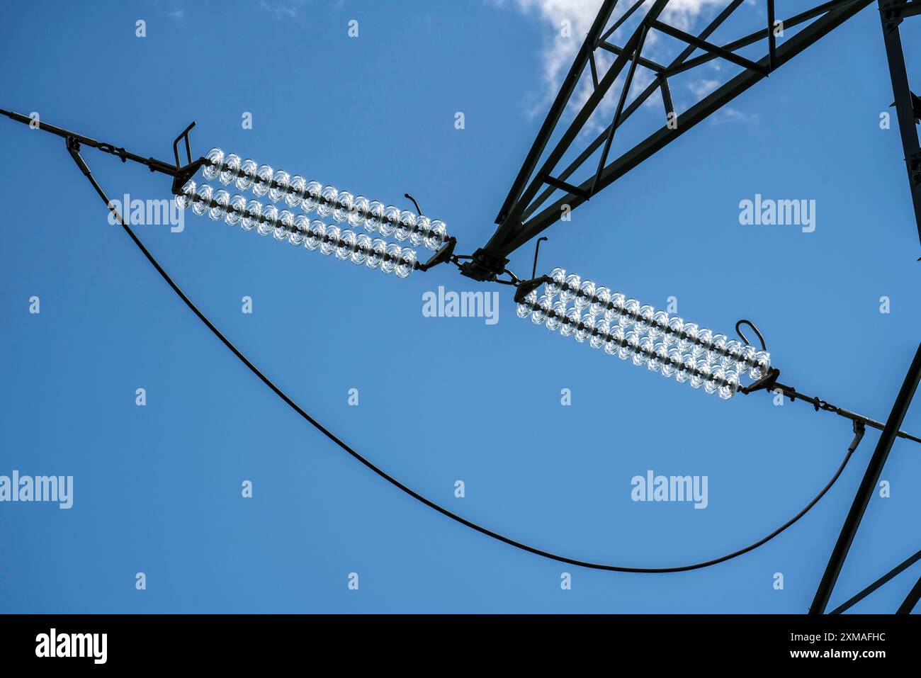 Insulators made of glass on a high-voltage line, they hang on the ...