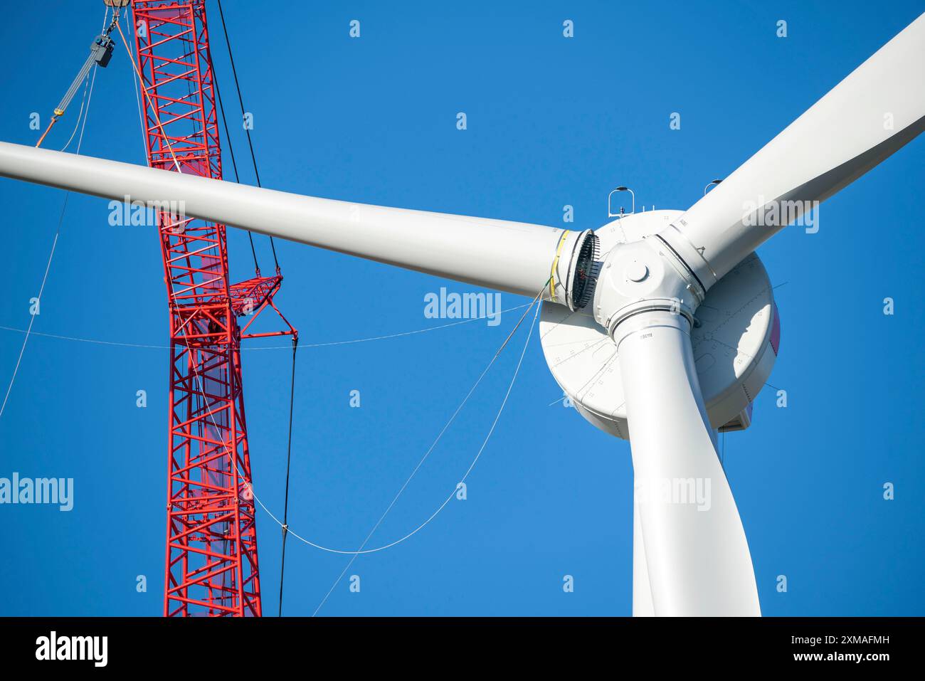 Assembly of a wind turbine, the last rotor blade is being mounted ...