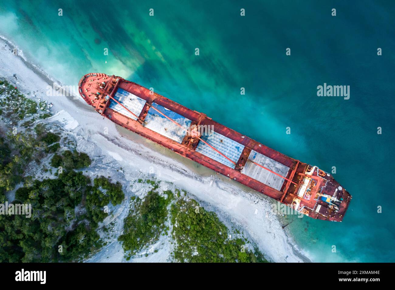 Aerial top down view of an abandoned bulk-carrier dry cargo ship washed ...