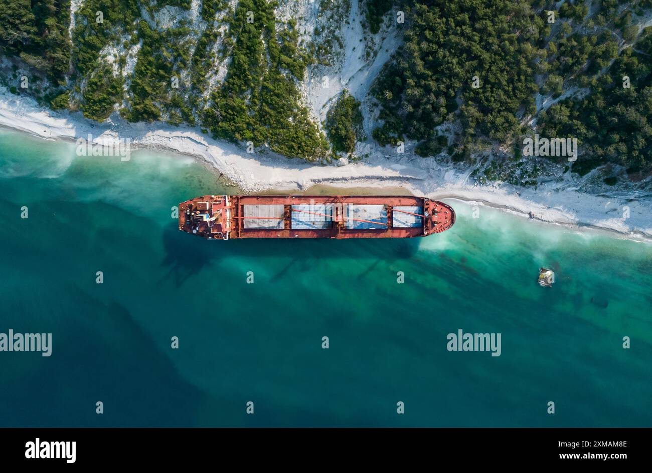 Aerial top down view of an abandoned bulk-carrier dry cargo ship washed ...