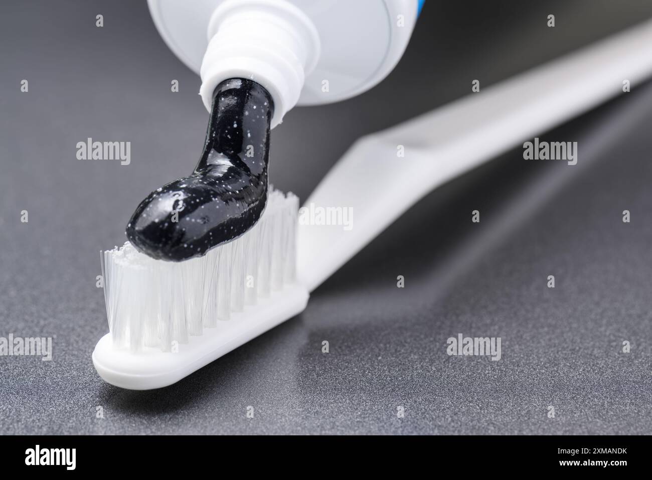 Black charcoal whitening toothpaste on white toothbrush Stock Photo - Alamy