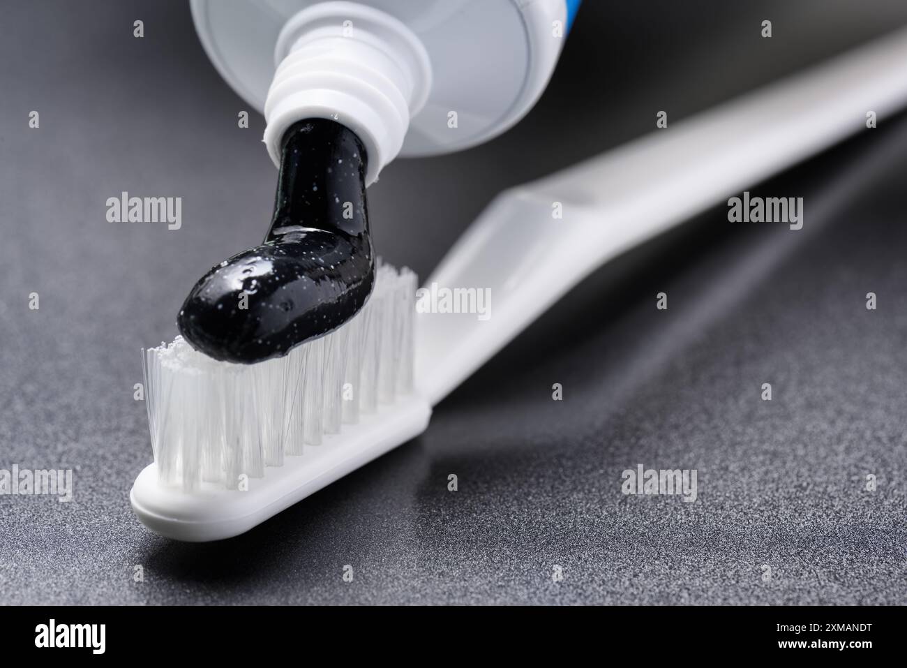 Black charcoal whitening toothpaste being squeezed from tube Stock ...