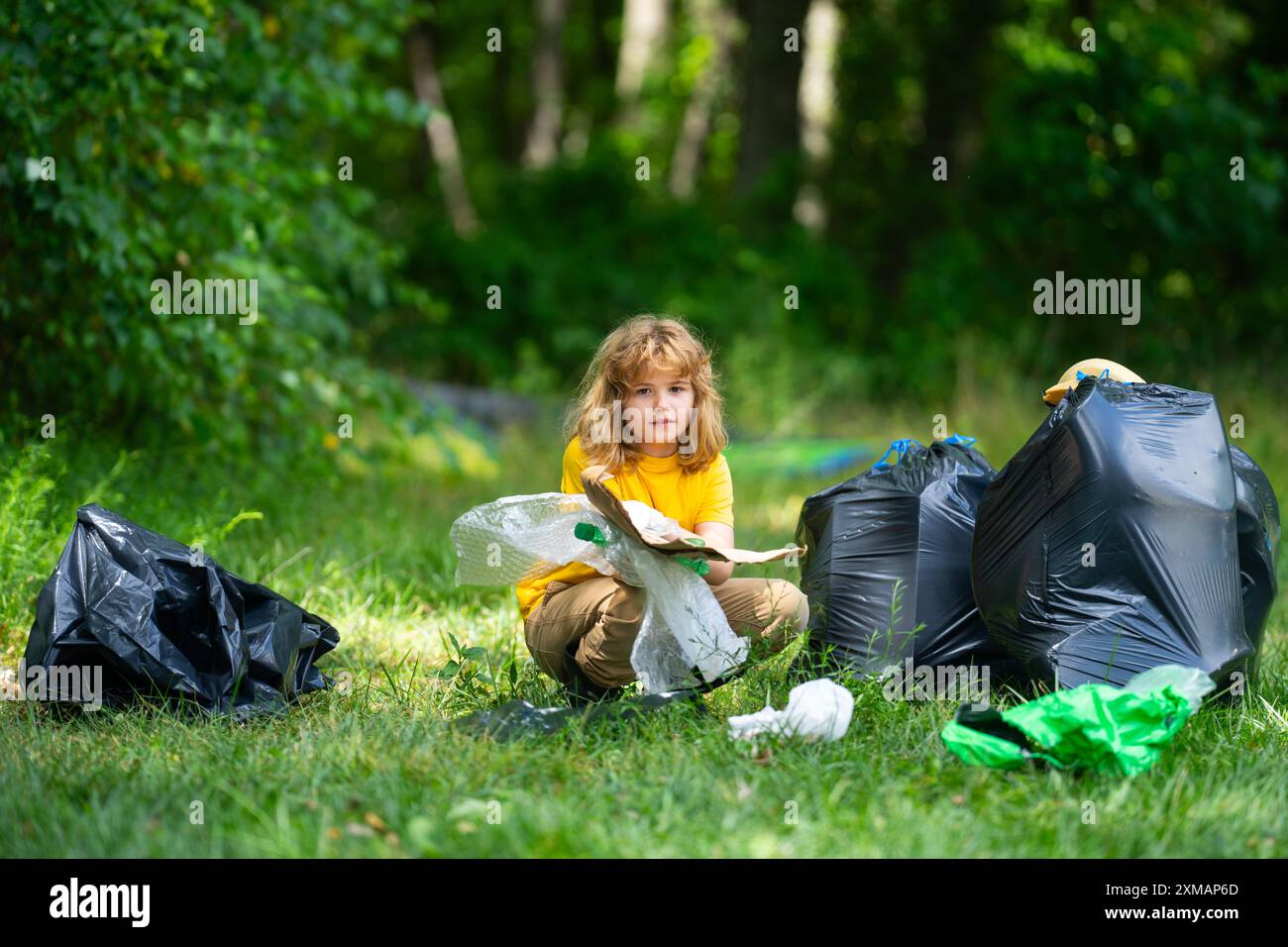 Global environmental pollution. Child collects plastic trash outdoor ...
