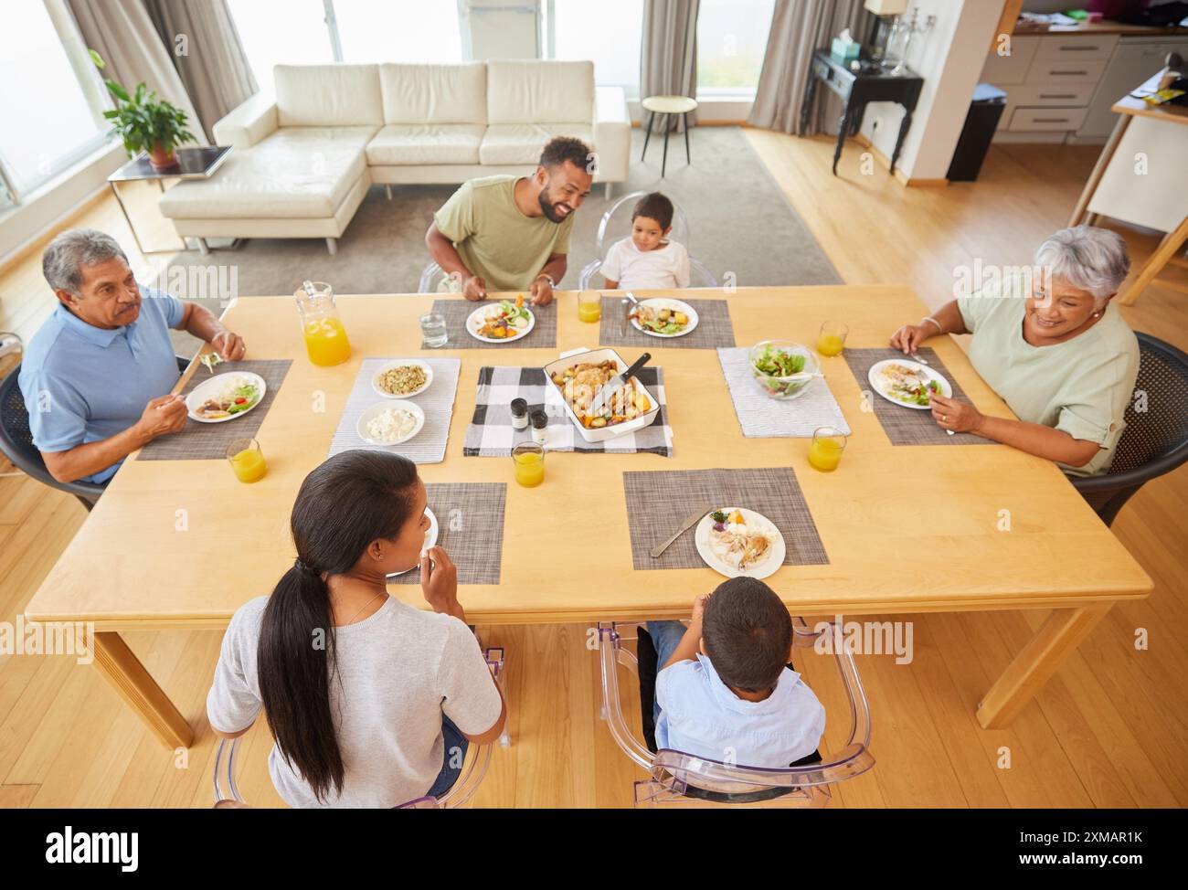 Happy family, dinner and eating food at table together for holiday ...