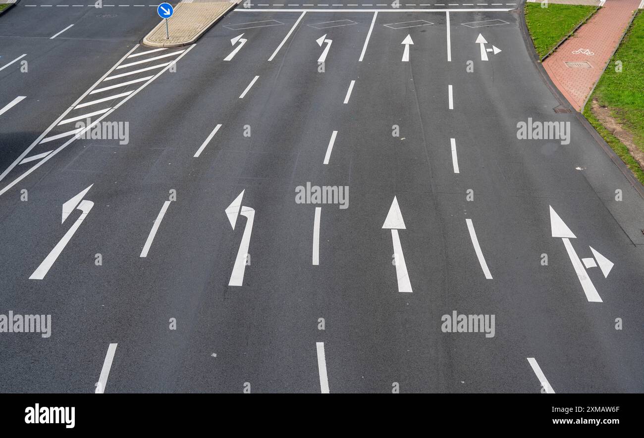 Road markings, turning lanes, directional signage at an intersection ...