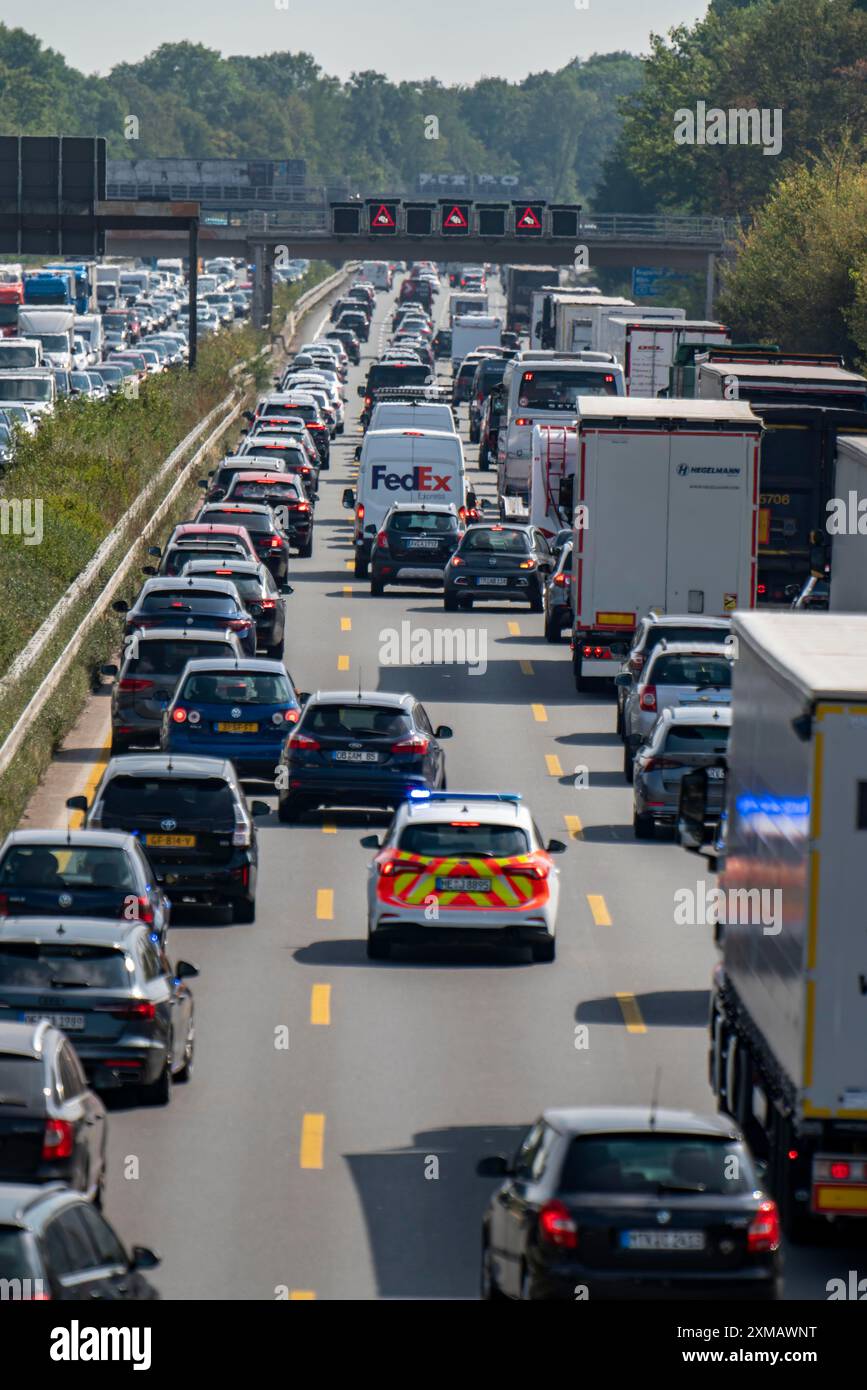 Emergency ambulance with flashing blue lights and siren working its way ...