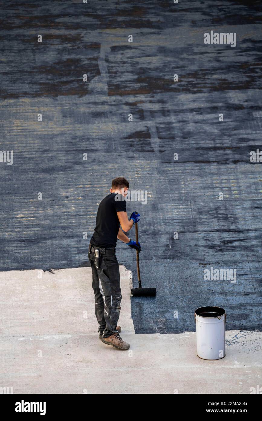 Construction site, application of a bitumen coating to a concrete ceiling, preparation for ...