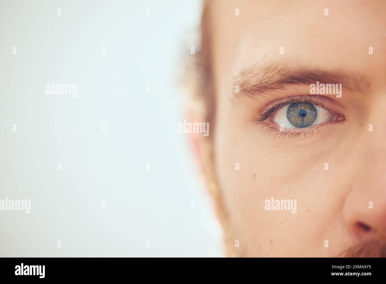 Half face, closeup and eye of man in studio isolated on white ...