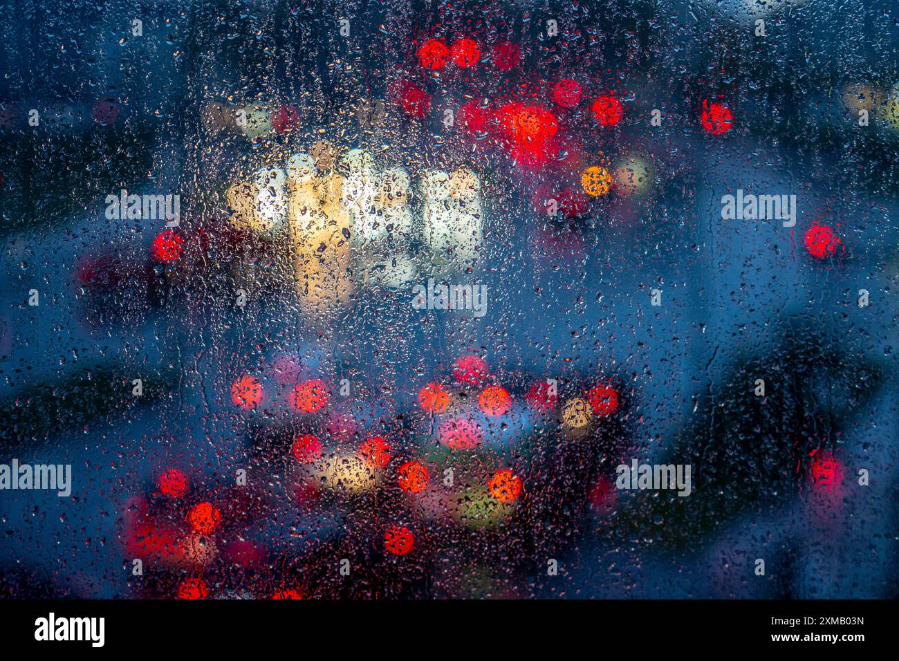 Rainy weather, road traffic, raindrops on a window pane, behind ...