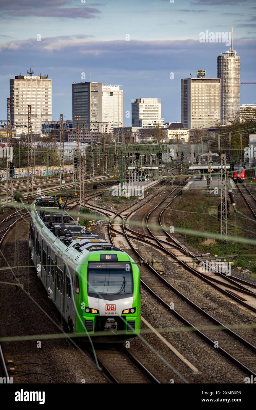 Train on the tracks west of Essen main station, skyline of the city ...