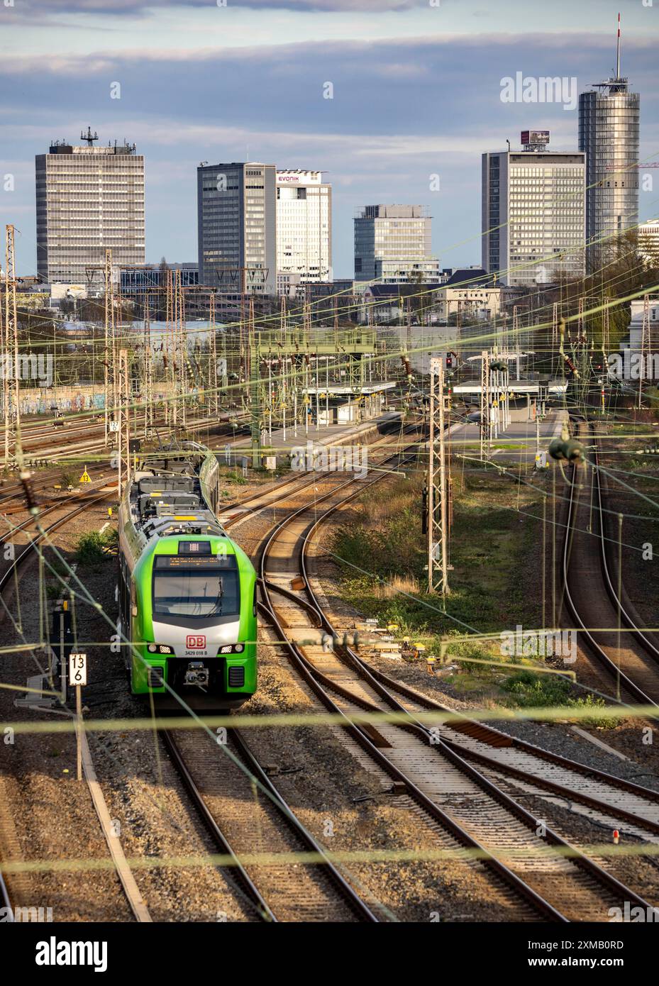 Train on the tracks west of Essen main station, skyline of the city ...