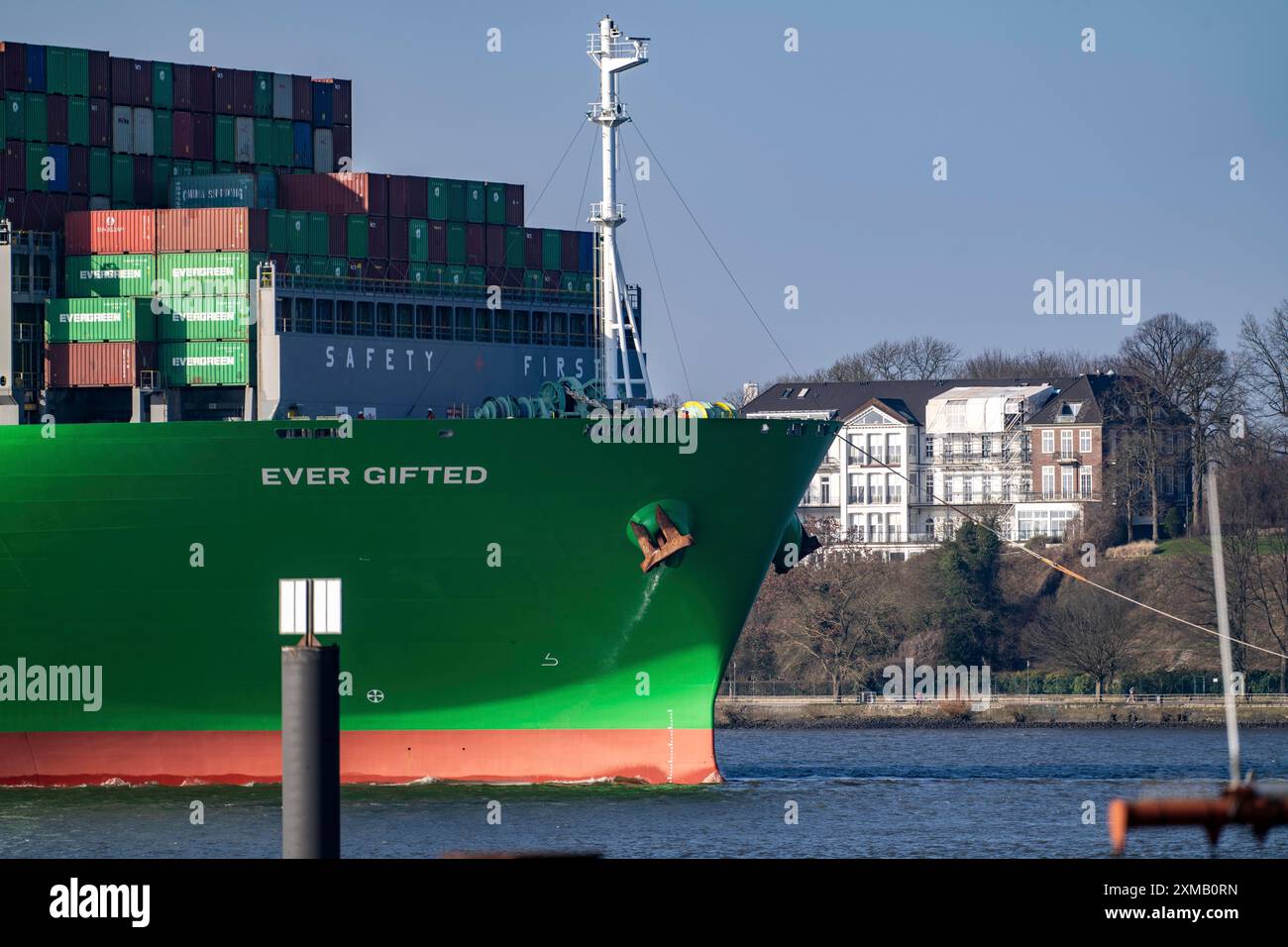 Container ship Ever Gifted, enters the port of Hamburg on the Elbe ...