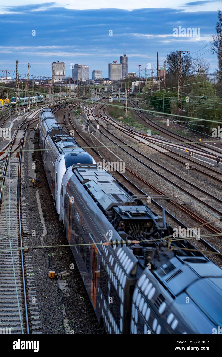 Train on the tracks west of Essen central station, city centre skyline ...