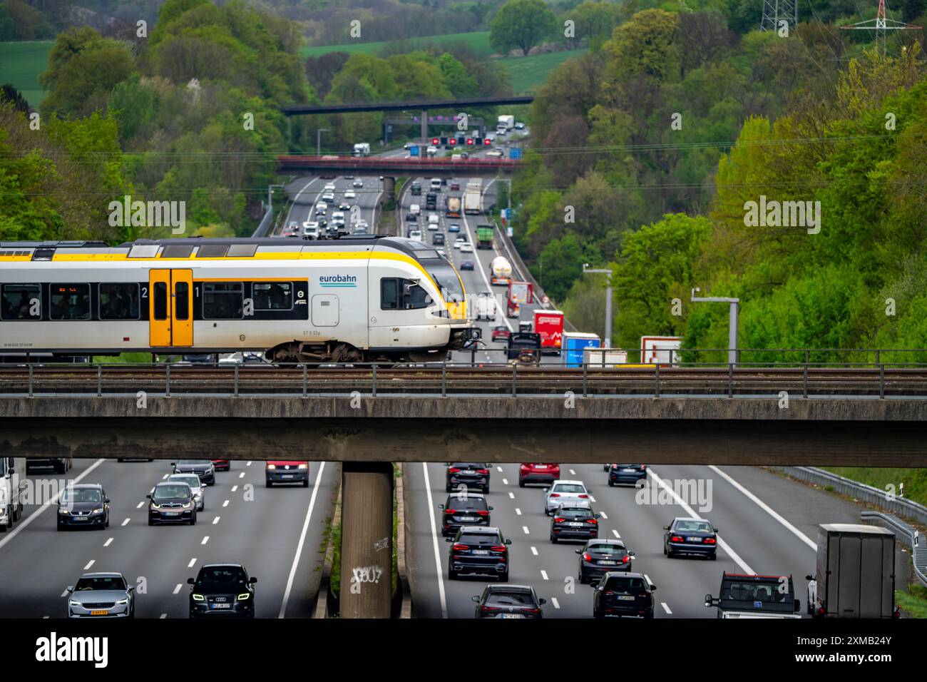 Eurobahn, regional train crossing the motorway A3, traffic on 8 lanes ...