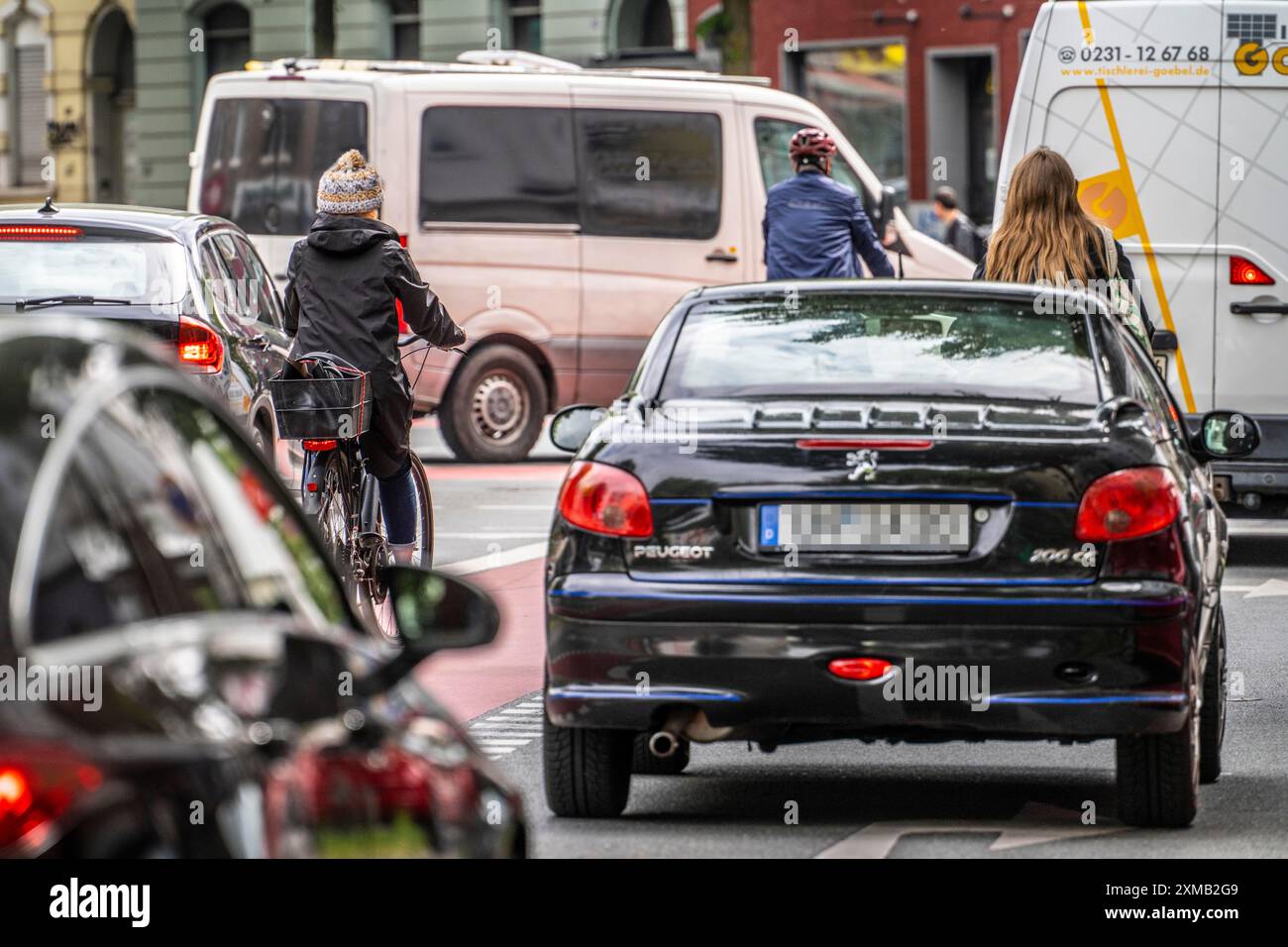 Bicycle lane, marked red, between 2 lanes for vehicles, city centre ...