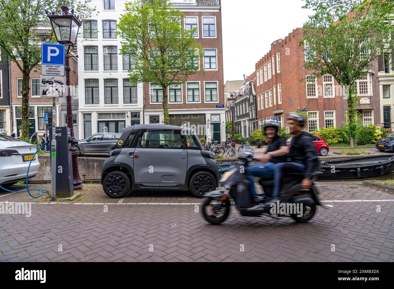 Mini car parked in the old town, Blauwburgwal canal, city centre of ...