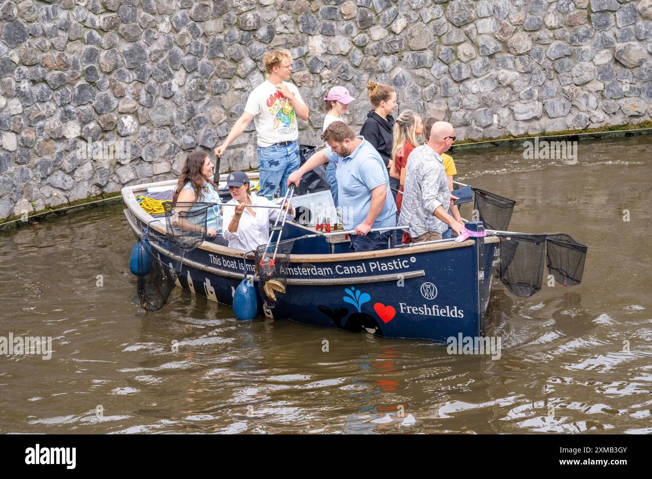 Plastic Whale boat in a canal in Amsterdam, passengers fish plastic ...