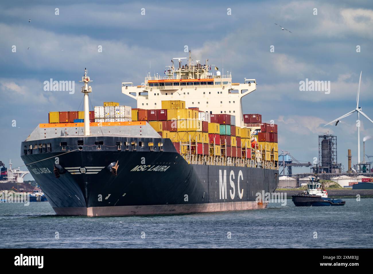 Europahaven, MSC Laura container freighter being towed by harbour tugs ...