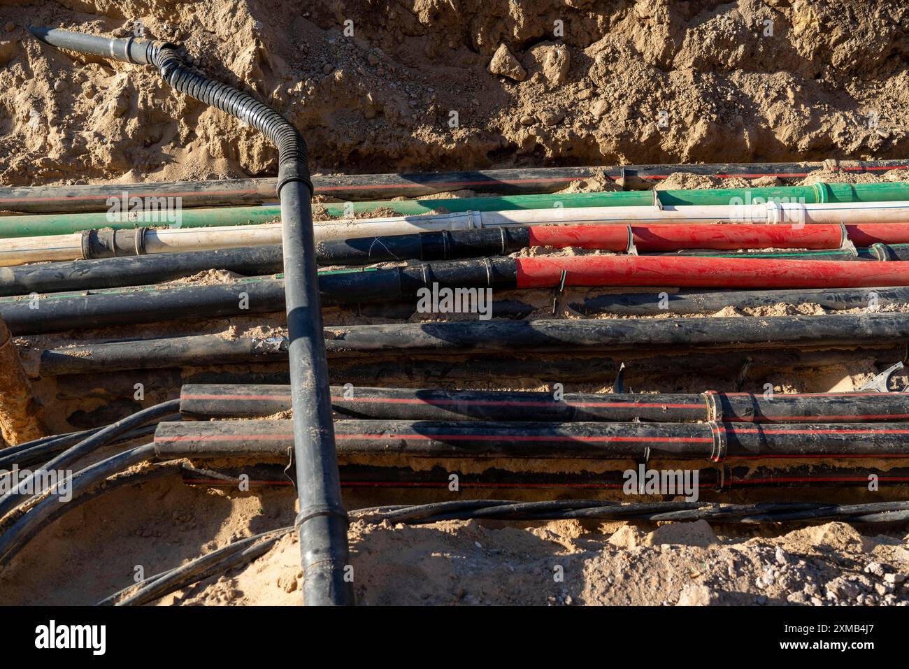 Cables, pipes, next to each other in a construction site, supply lines ...