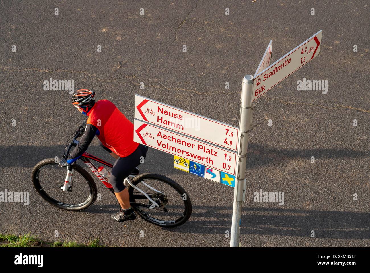 Cyclists on a path, Rhine embankment path, signpost for cyclists ...