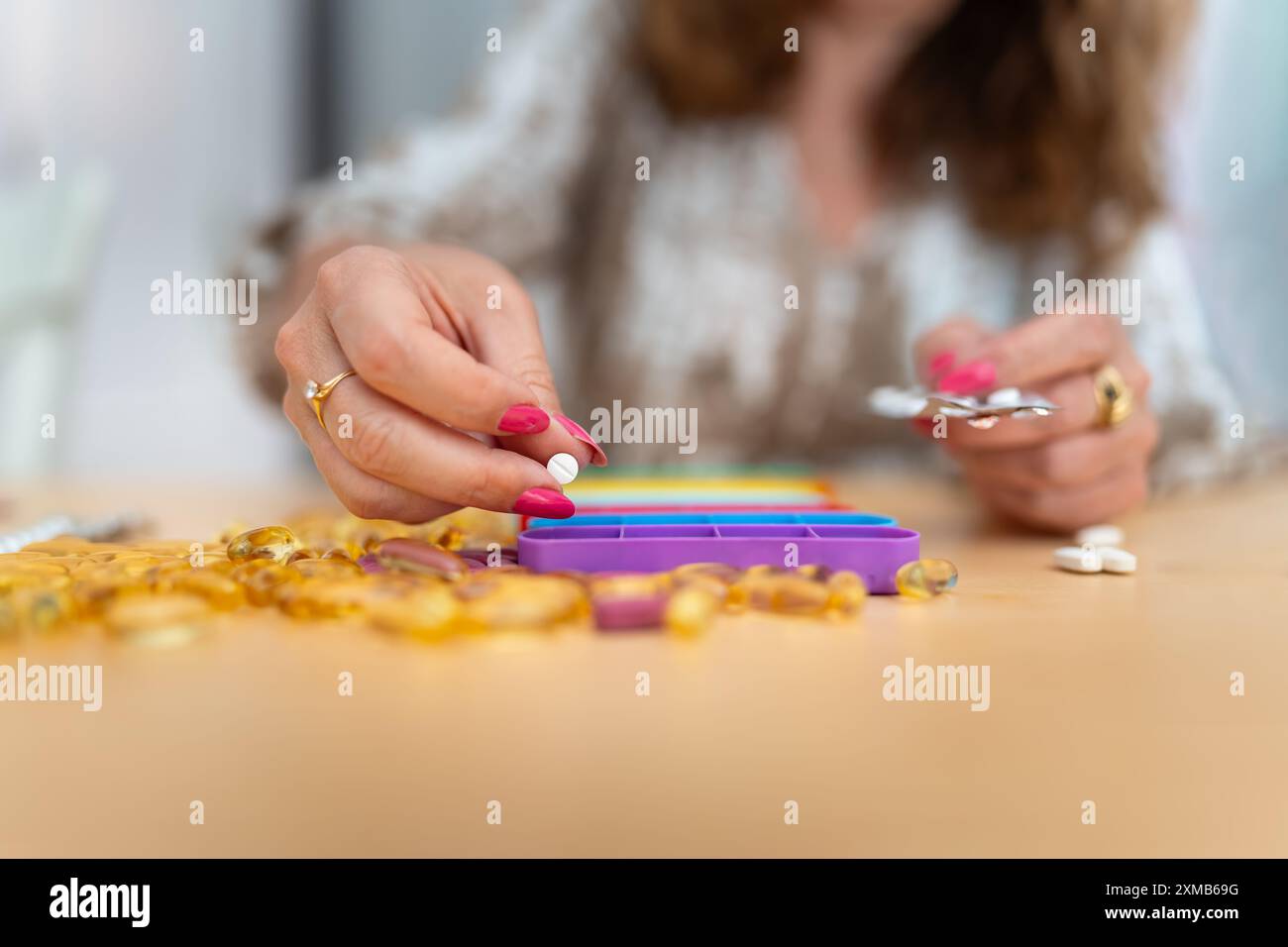 Woman placing medicines pill box hi-res stock photography and images ...