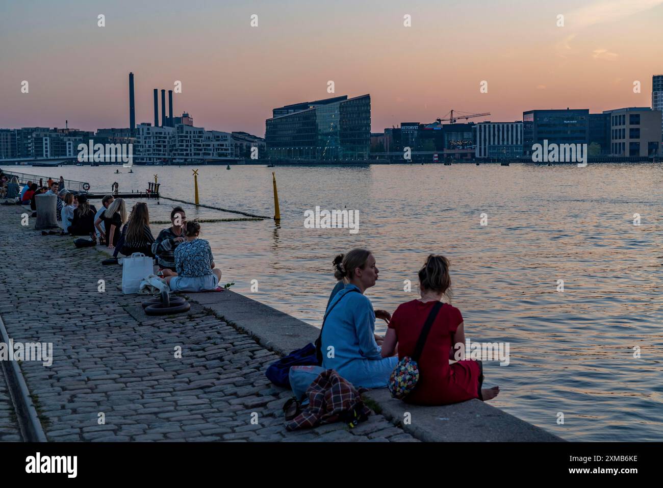 Summer evening in Copenhagen, at the harbour, Islands Brygge, people ...