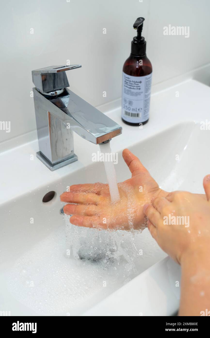 Domestic hygiene, washing hands with liquid soap, boy 9 years old Stock ...