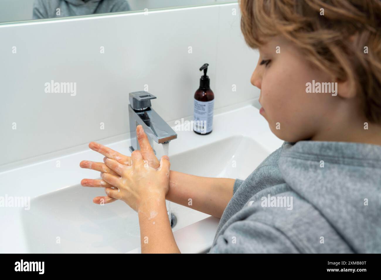 Domestic hygiene, washing hands with liquid soap, boy 9 years old Stock ...