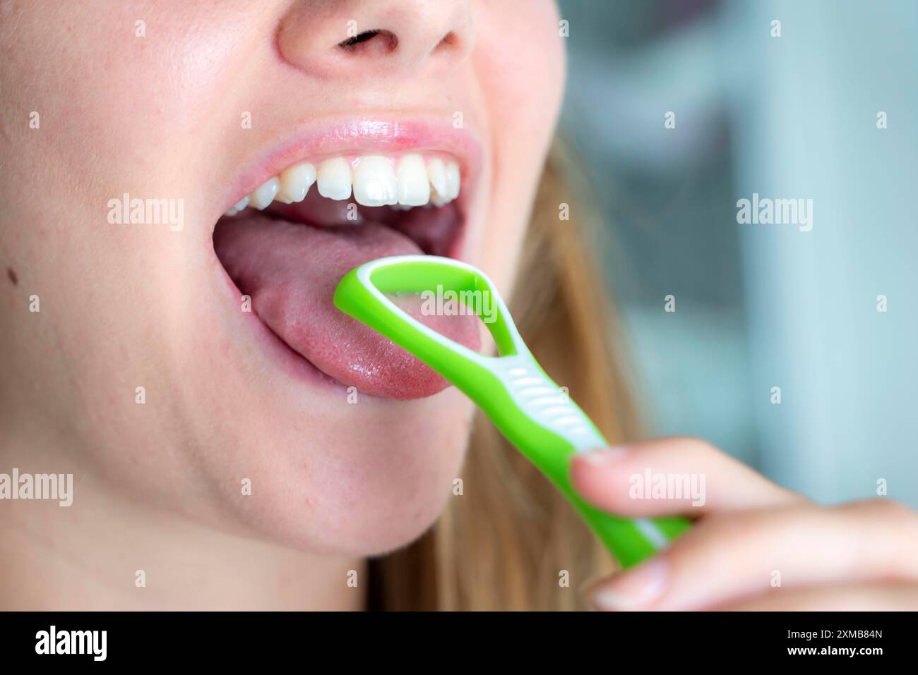 Bad breath, prevention by cleaning the tongue with a tongue brush Stock ...