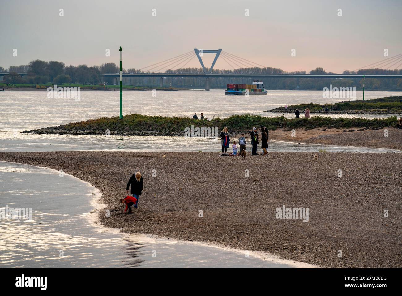 Walkers on the Rhine beach between Duesseldorf and Krefeld, container ...