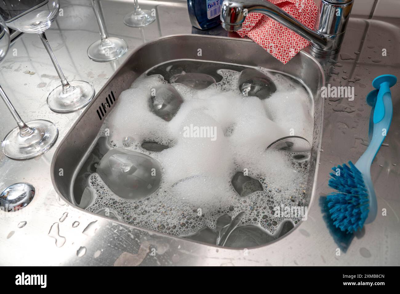 Kitchen after a big dinner, cooking party, sink with dirty glasses ...