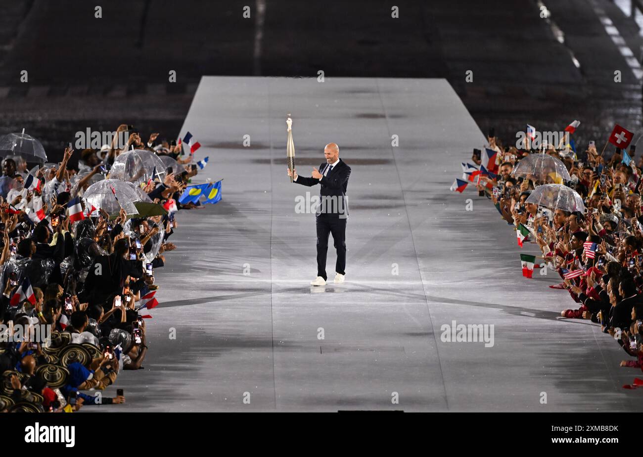 Zinedine Zidane with the Olympic Flame during the opening ceremony of ...