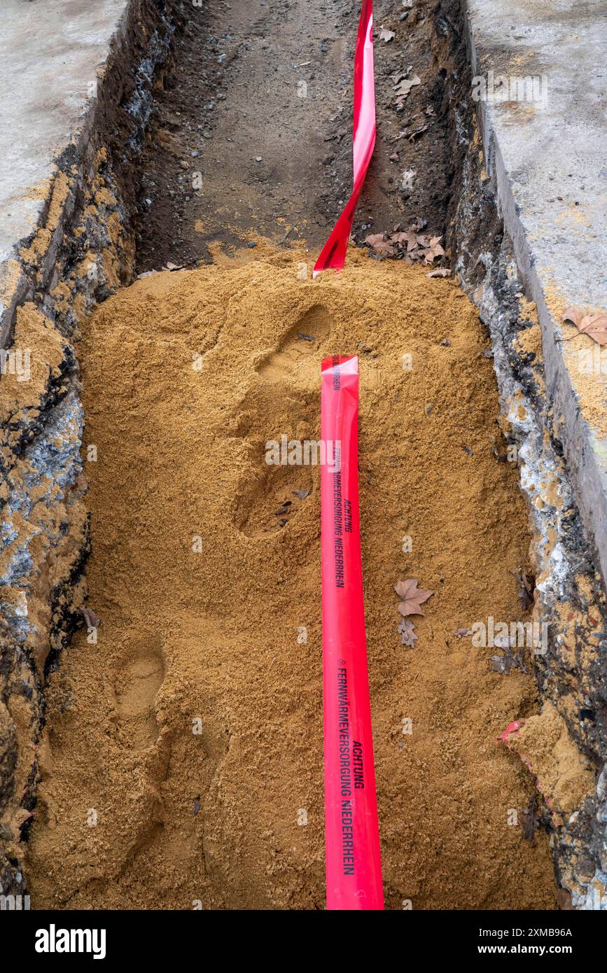 Indications in an excavation pit above laid district heating pipes, in ...