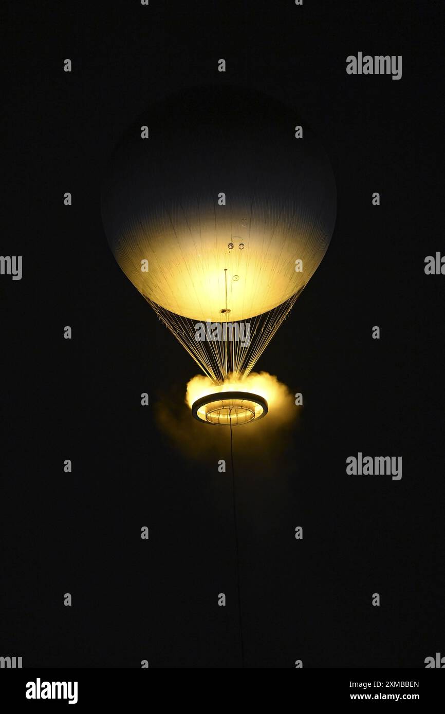 The cauldron, with the Olympic flame lit, lifting off attached to a ...