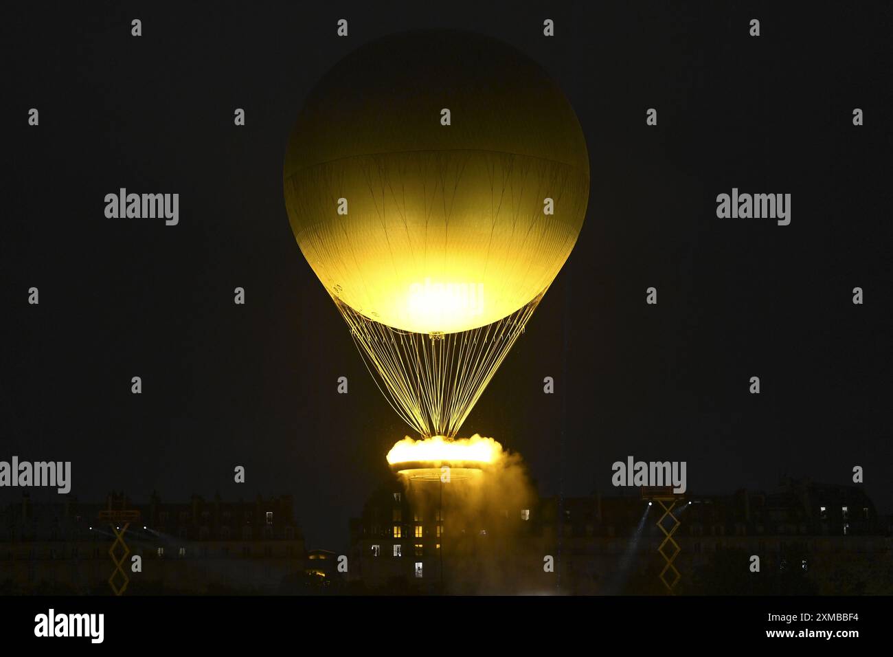 The cauldron, with the Olympic flame lit, lifting off attached to a ...