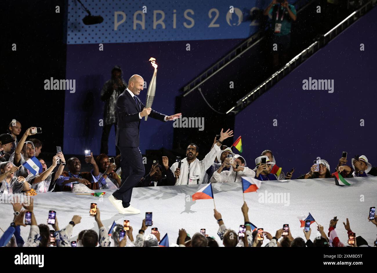 Zinedine Zidane with the Olympic Flame during the opening ceremony of ...