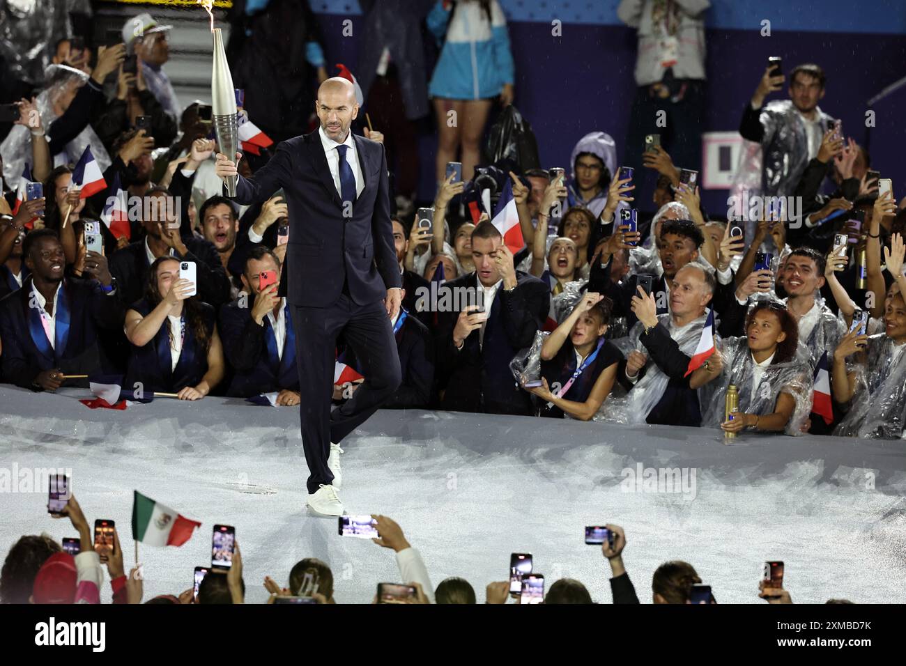 Zinedine Zidane with the Olympic Flame during the opening ceremony of ...