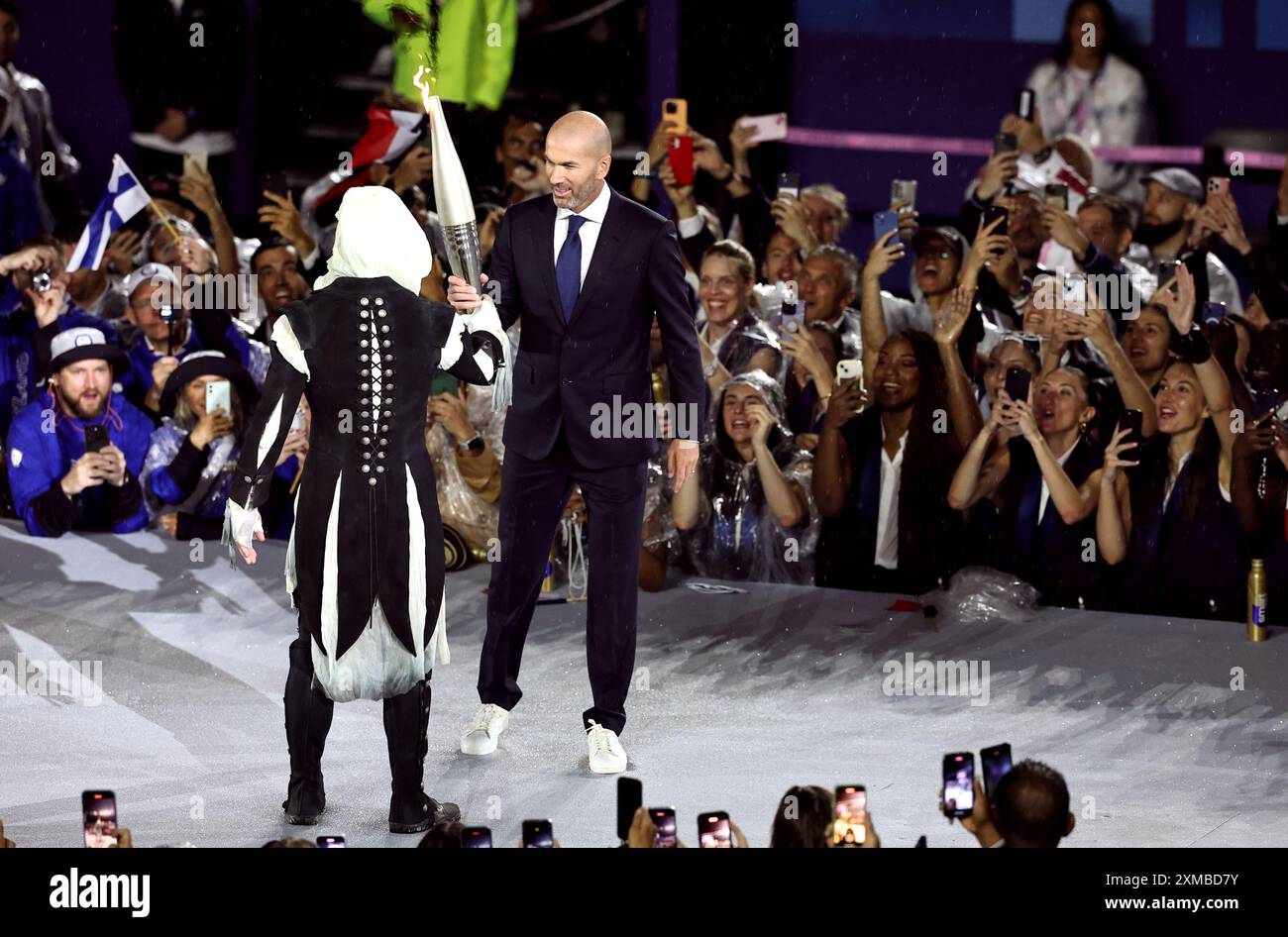 Zinedine Zidane with the Olympic Flame during the opening ceremony of ...