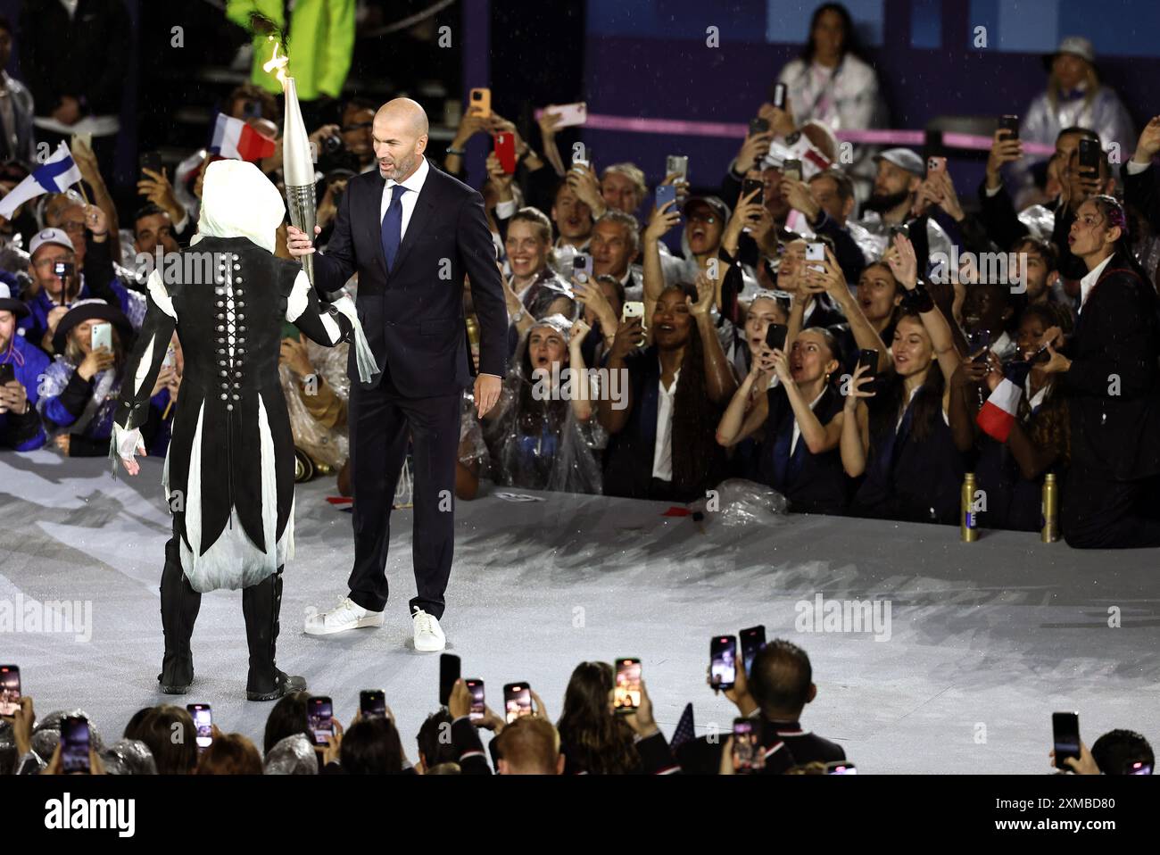 Zinedine Zidane with the Olympic Flame during the opening ceremony of ...