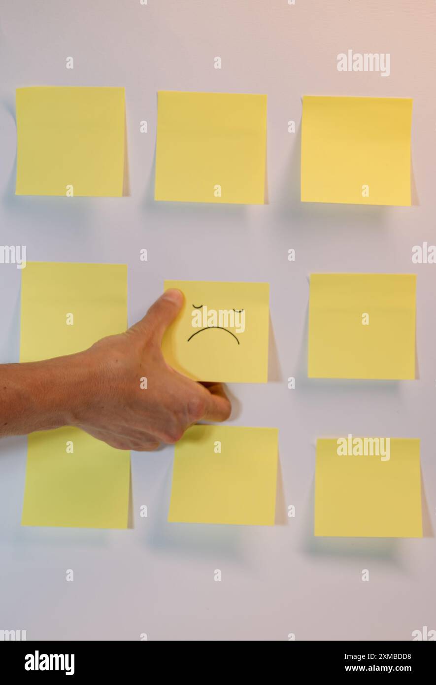 A hand holding a yellow pole is sadly surrounded by several yellow ...