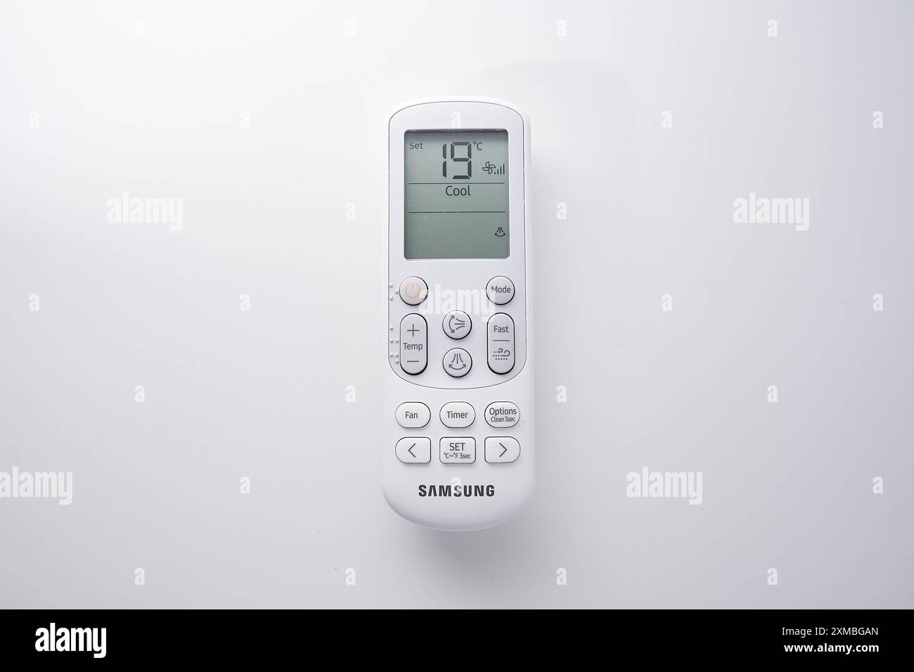 A white SAMSUNG Air Conditioner (AC) remote controller with LCD screen ...