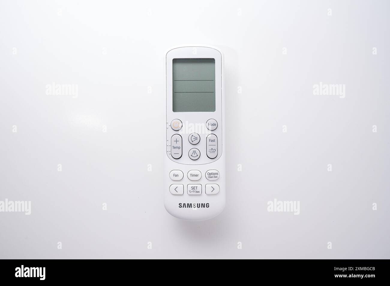 A white SAMSUNG Air Conditioner (AC) remote controller with LCD screen ...