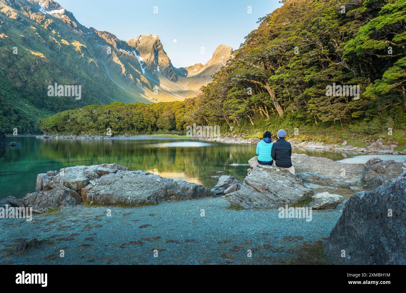 Couple sitting on the rocks and enjoying the views of Lake Mackenzie at ...