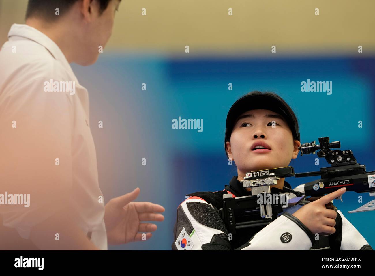 South Korea's Keum Jihyeon is instructed by her coach as she competes ...